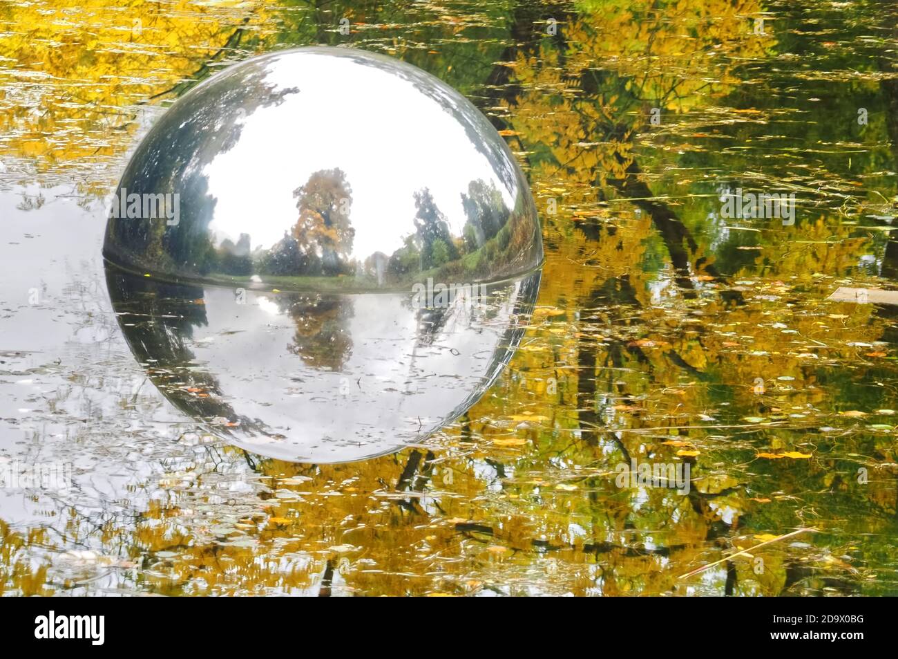 Art and nature - Big silver ball in the water shows the world Stock ...