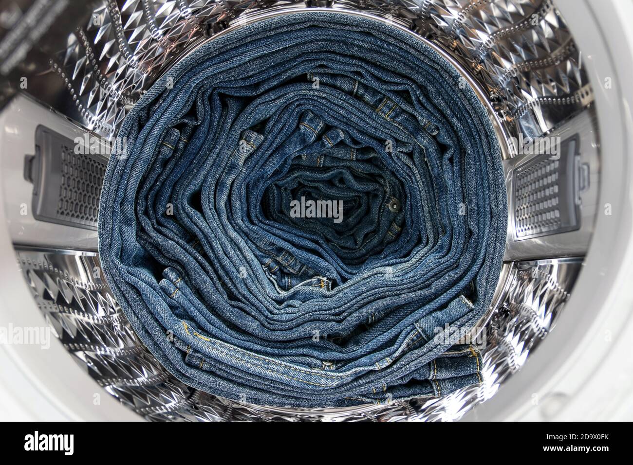 Closeup group of blue jeans inside the washing machine Stock Photo - Alamy