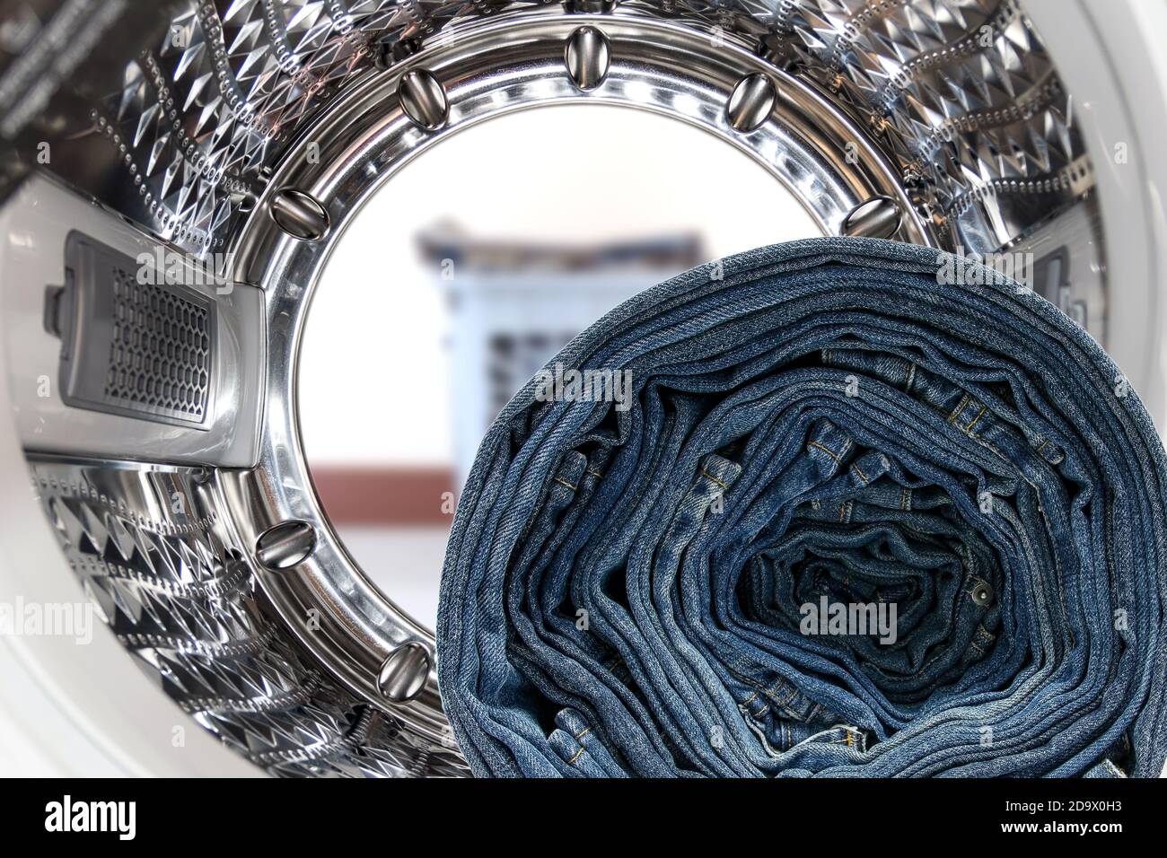 Closeup group of blue jeans inside the washing machine Stock Photo - Alamy