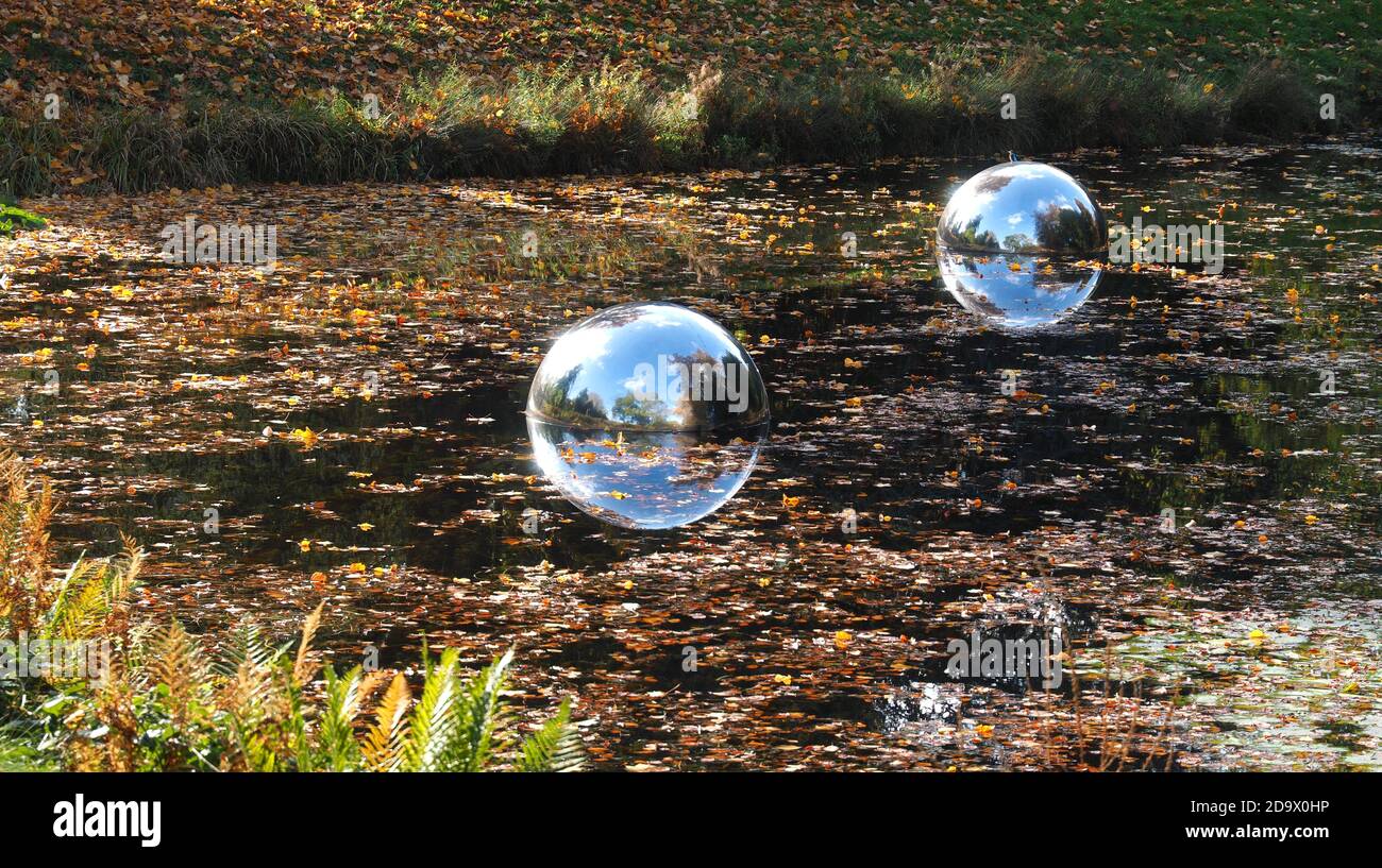 Art and nature - Big silver balls in the water show the world Stock ...