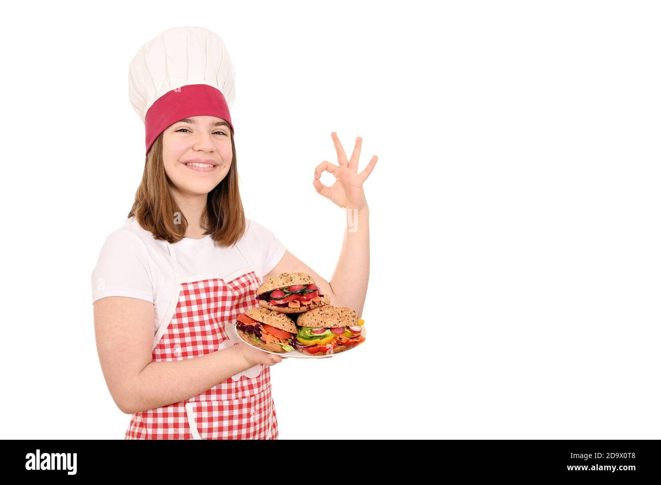 female cook with ok hand sign and plates with vegan sandwiches Stock ...