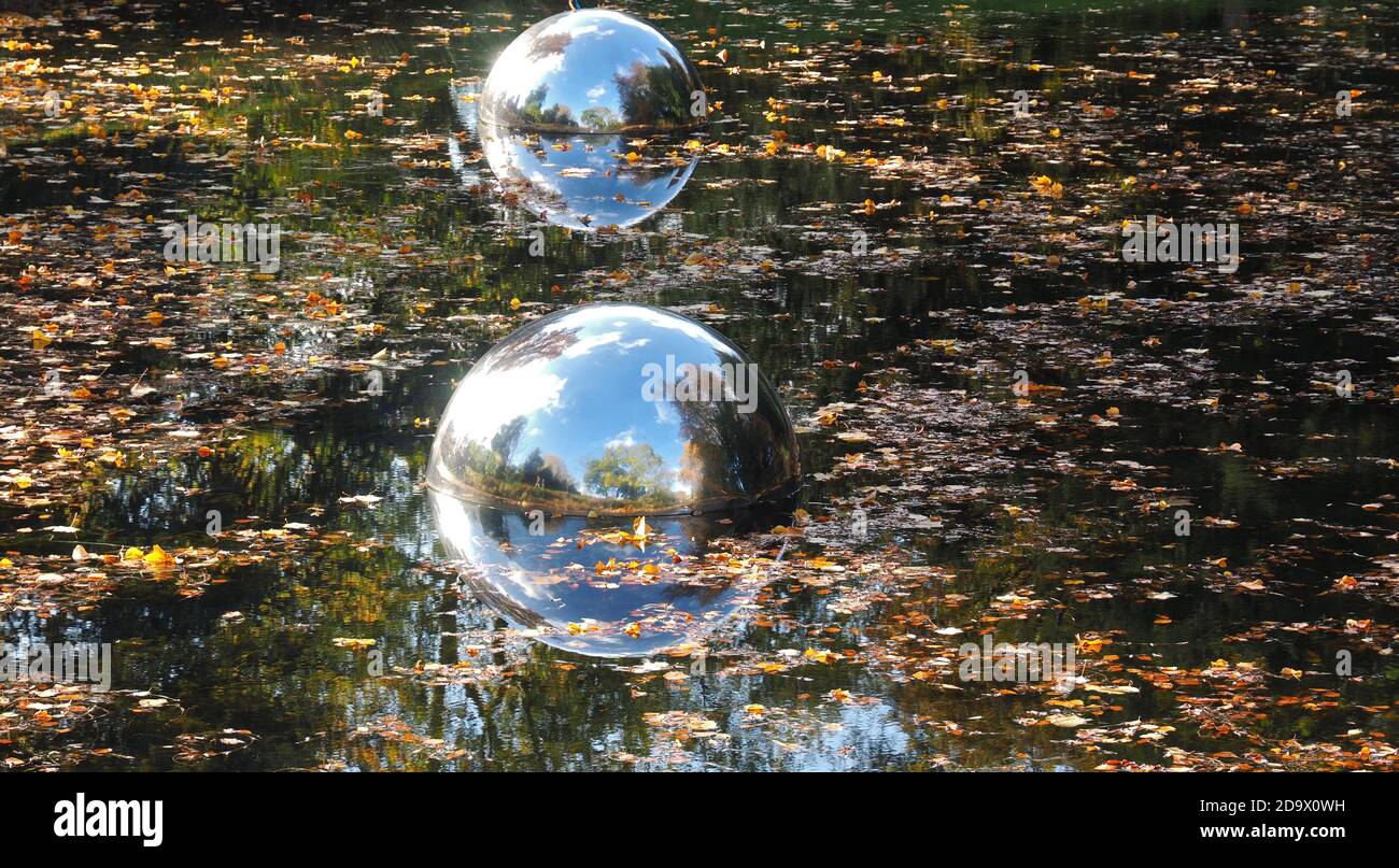 Art and nature - Big silver balls in the water show the world Stock ...