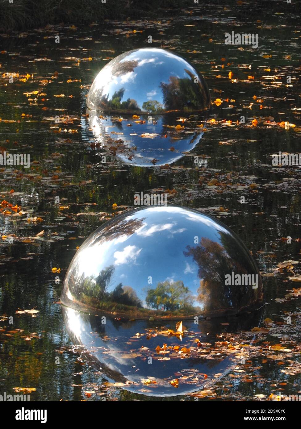 Art and nature - Big silver balls in the water show the world Stock ...