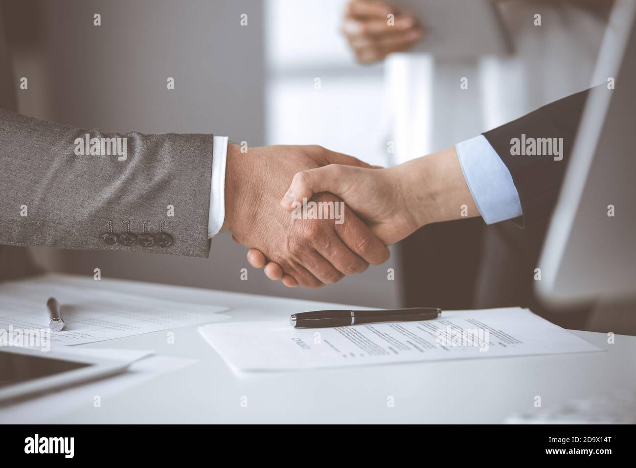 Business people shaking hands finishing contract signing, close-up ...