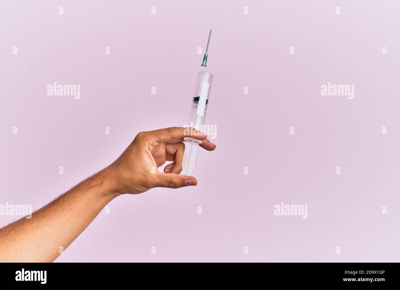 Hand syringe over pink background hi-res stock photography and images ...