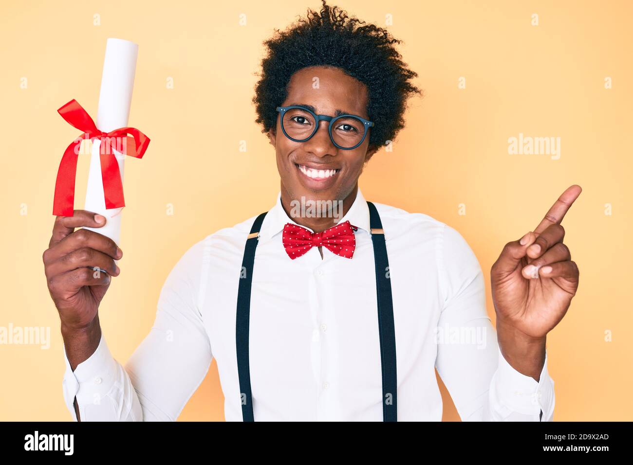 Handsome african american nerd man with afro hair holding graduate ...