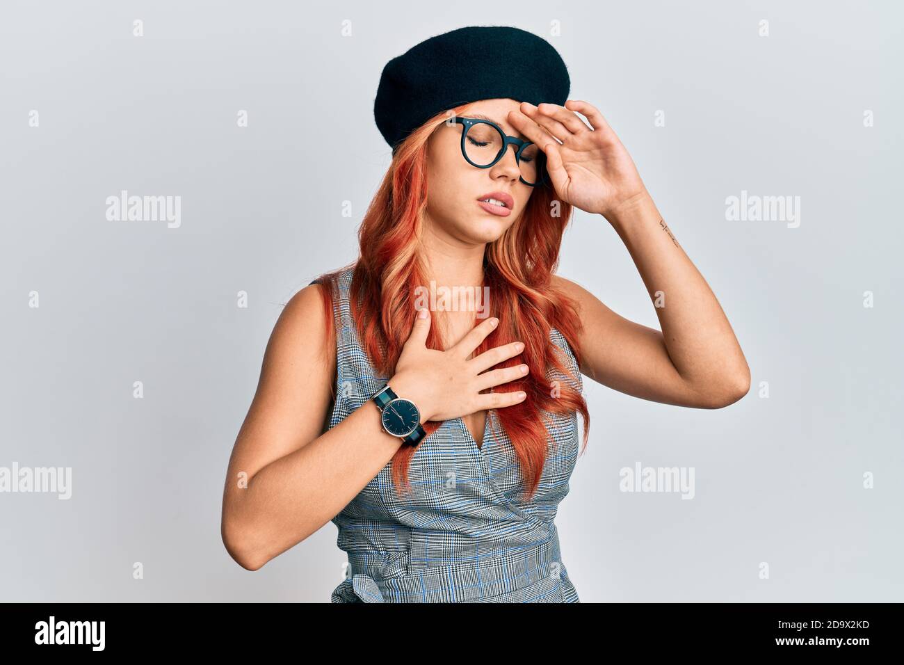 Young redhead woman wearing fashion french look with beret touching ...