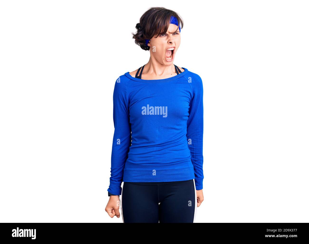 Beautiful young woman with short hair wearing training workout clothes ...