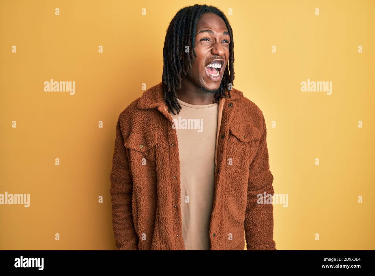 African american man with braids wearing brown retro jacket angry and ...