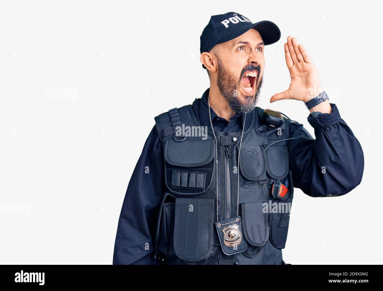 Young handsome man wearing police uniform shouting and screaming loud ...