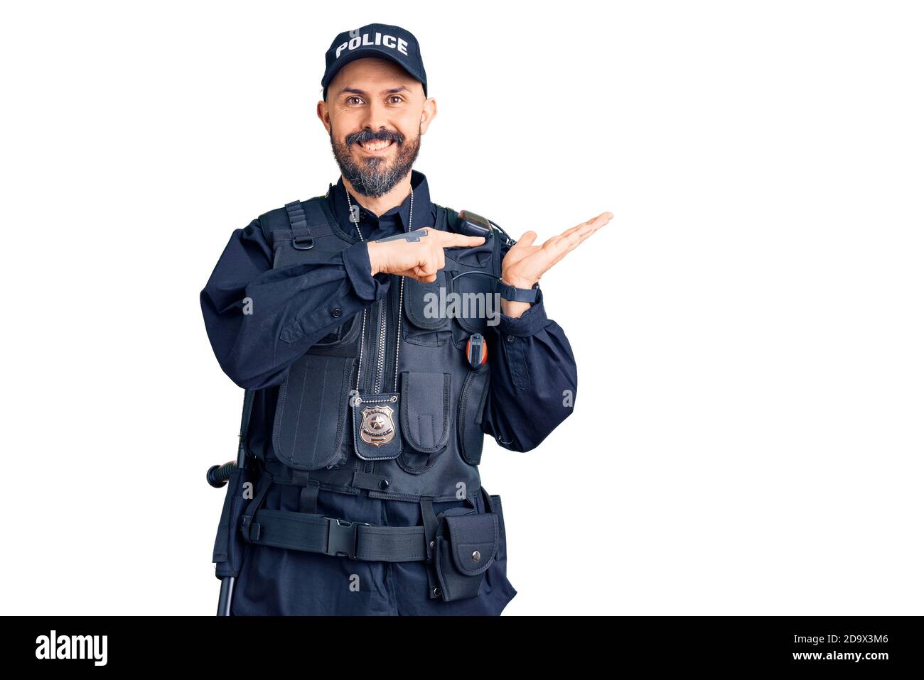 Young handsome man wearing police uniform amazed and smiling to the ...