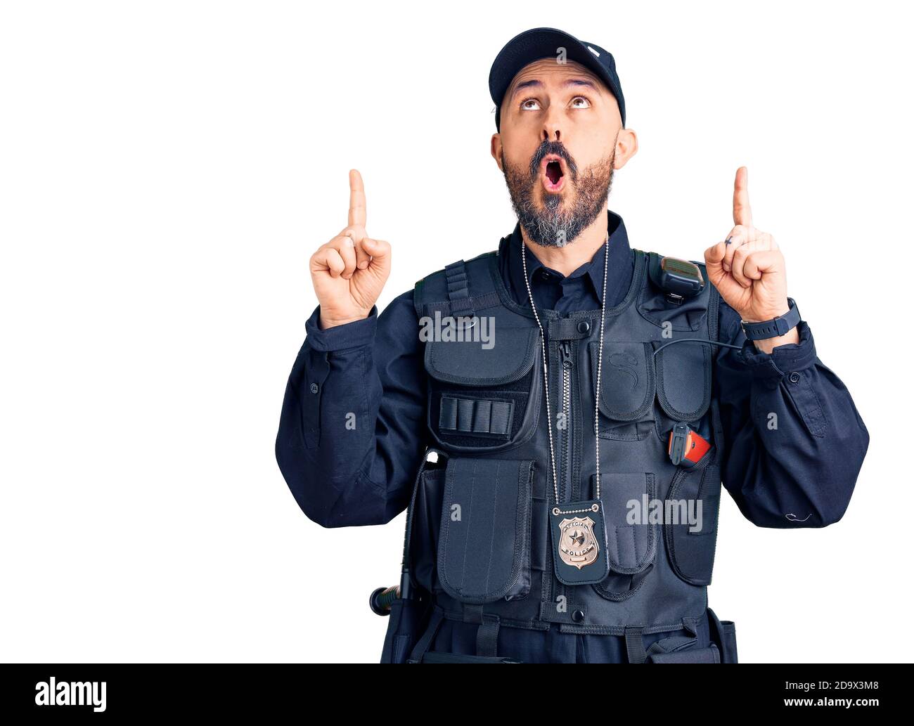 Young handsome man wearing police uniform amazed and surprised looking ...