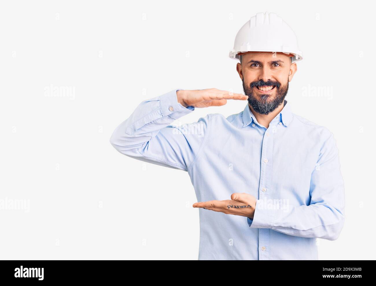 Young handsome man wearing architect hardhat gesturing with hands ...