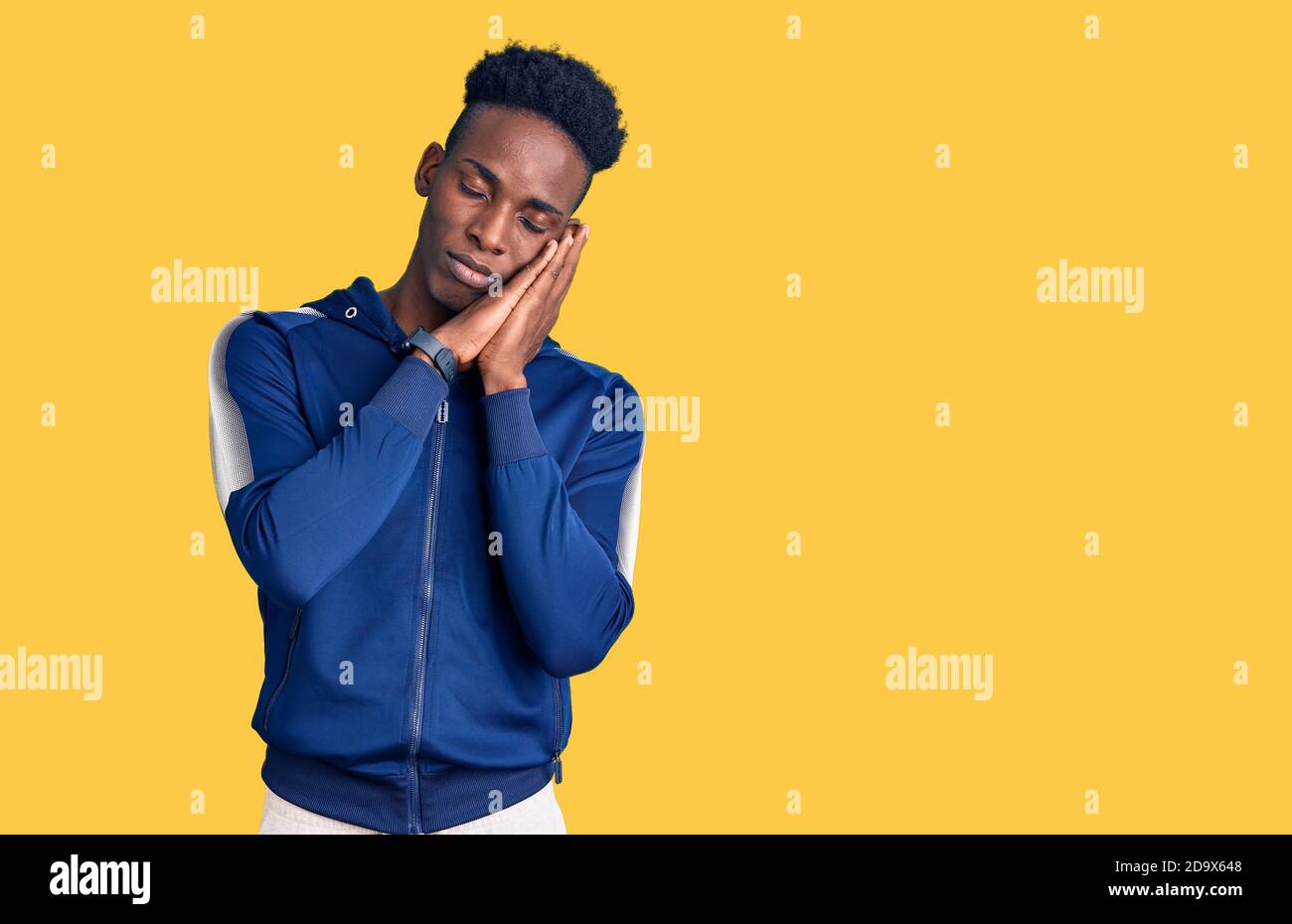 Young african american man wearing sportswear sleeping tired dreaming ...