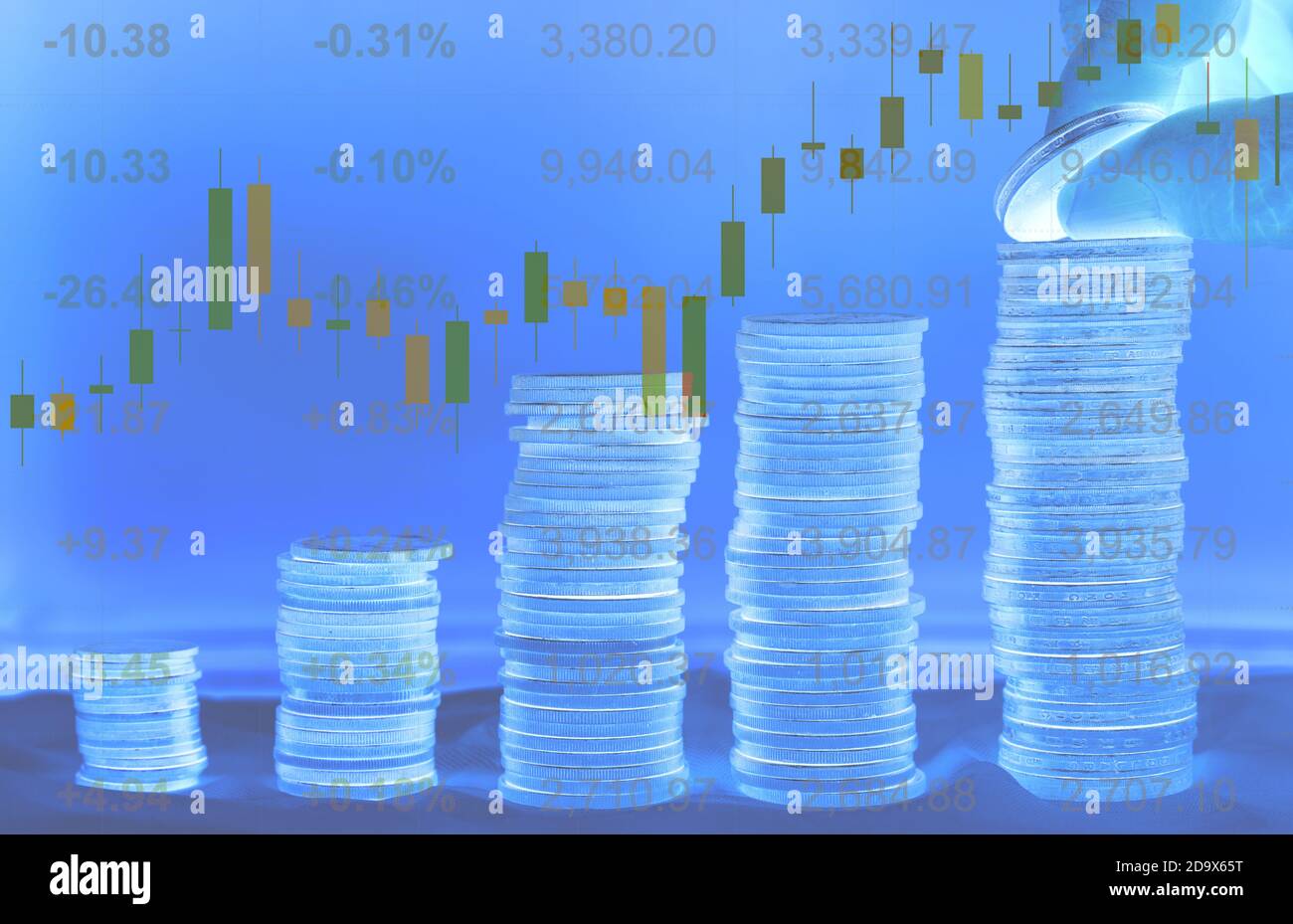Increasing piles of coins with candle stick graph chart and financial ...