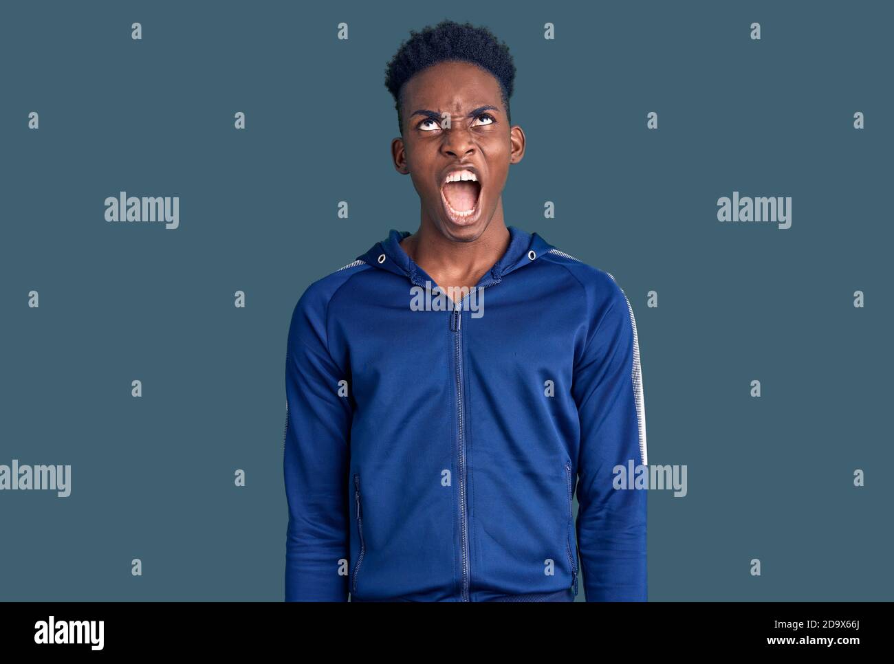 Young african american man wearing sportswear angry and mad screaming ...