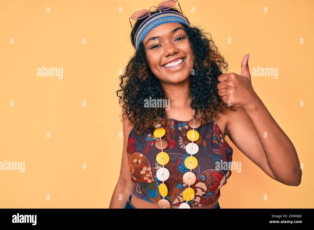 Young african american woman wearing bohemian and hippie style smiling ...