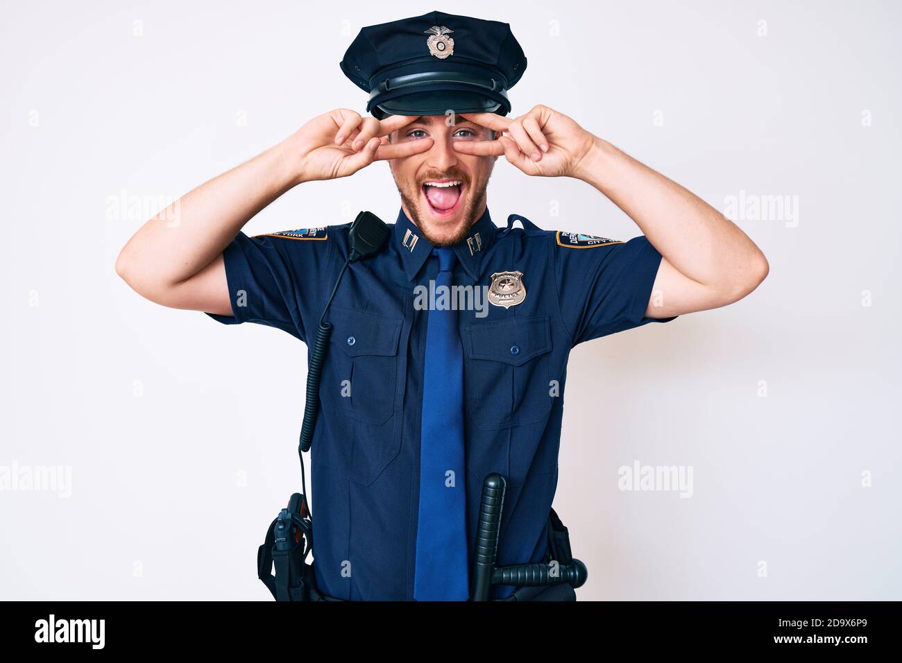 Young caucasian man wearing police uniform doing peace symbol with ...