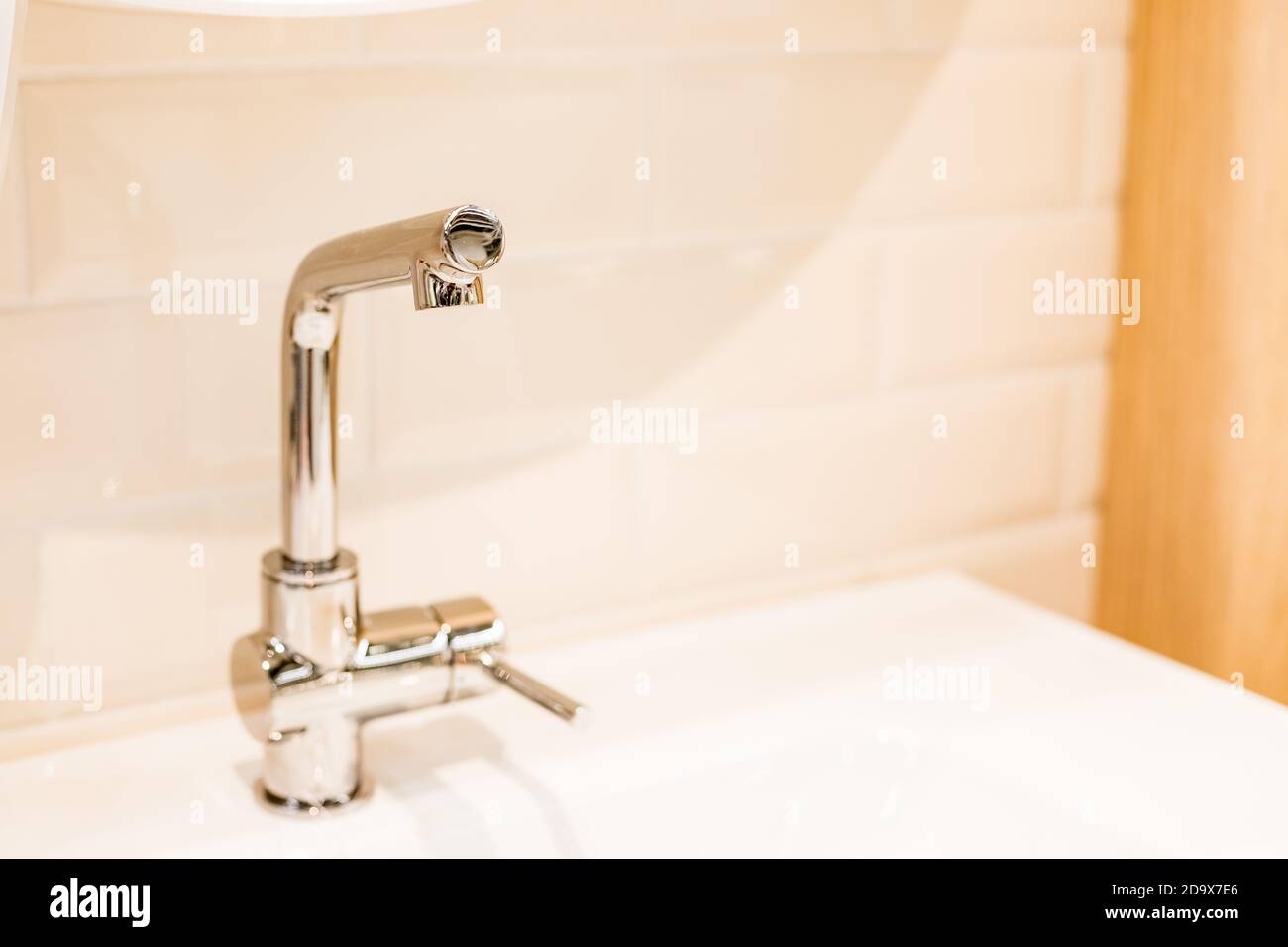 Chrome water faucet with marble counter tops and a white sink.Luxury ...