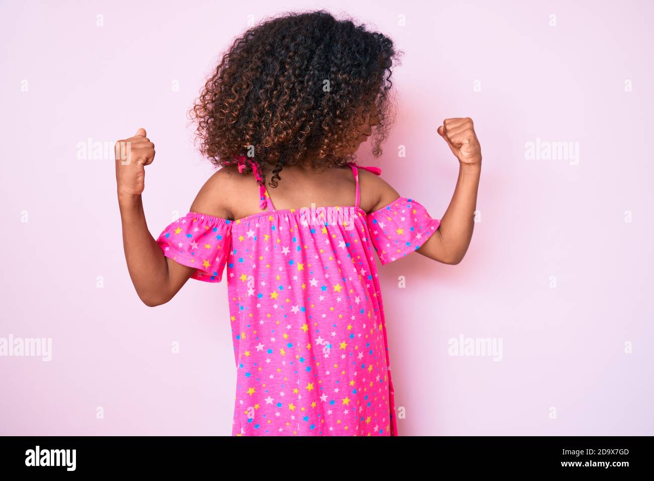 African american child with curly hair wearing casual dress showing ...