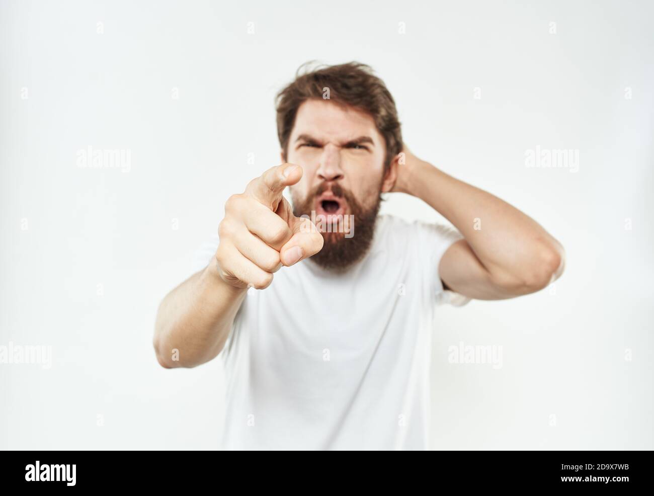 An emotional man on a light background gestures with his hands Copy ...