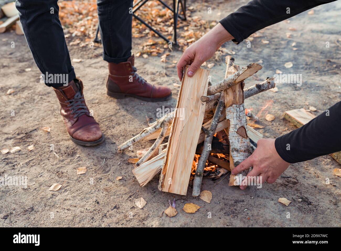 The concept of hiking and outdoor recreation. Making a fire Stock Photo ...