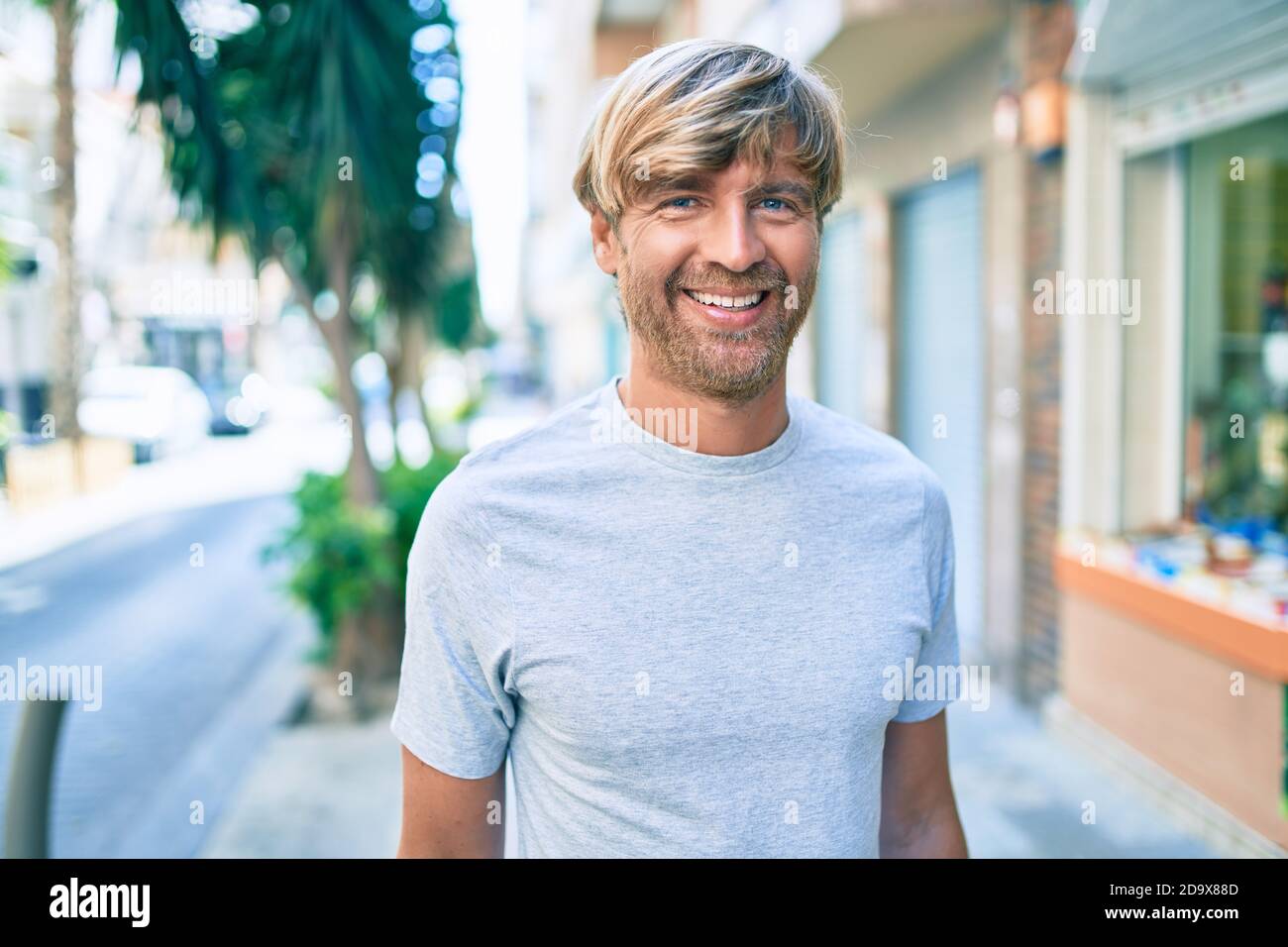 Young irish man smiling happy walking at street of city Stock Photo - Alamy