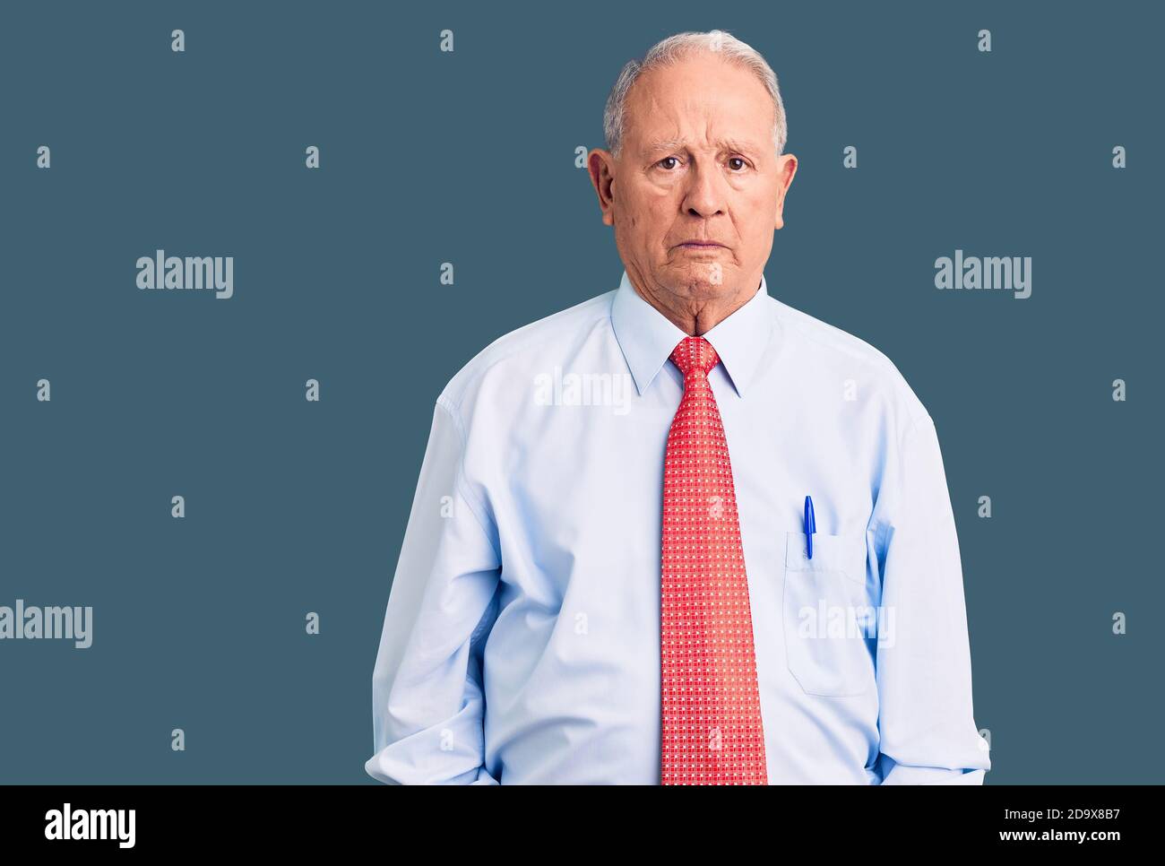 Senior handsome grey-haired man wearing elegant tie and shirt depressed ...