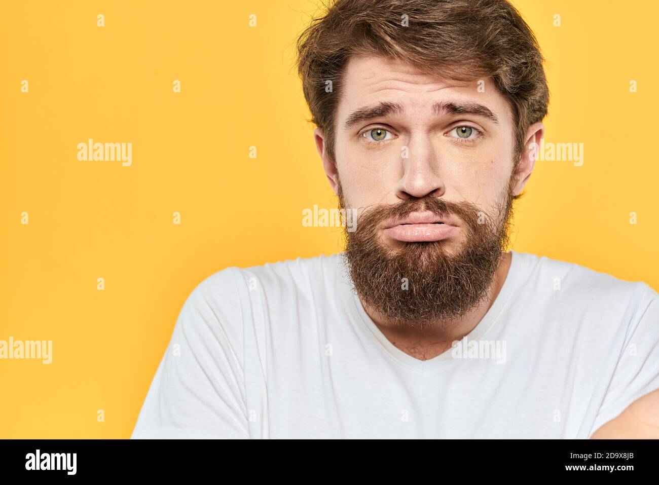 Man in white t-shirt emotions studio gestures with hands displeased ...