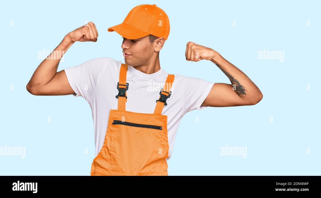 Young handsome african american man wearing handyman uniform showing ...