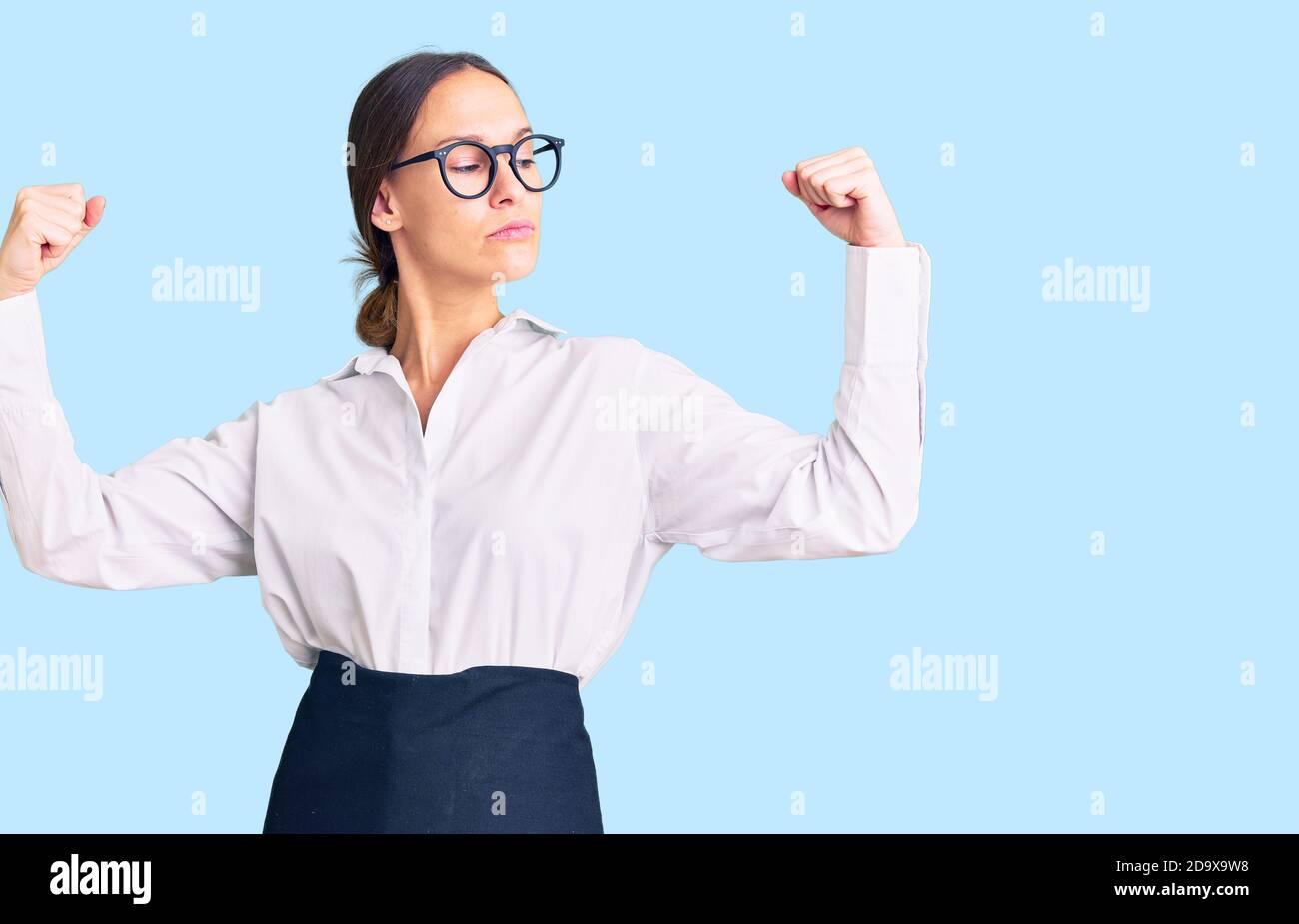 Beautiful brunette young woman wearing professional waitress apron ...
