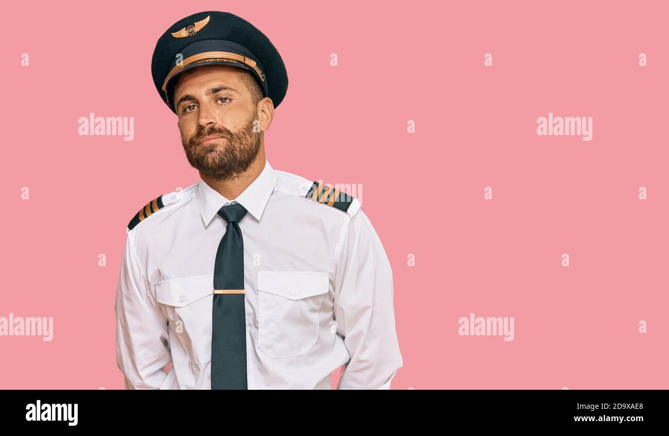 Handsome man with beard wearing airplane pilot uniform depressed and ...