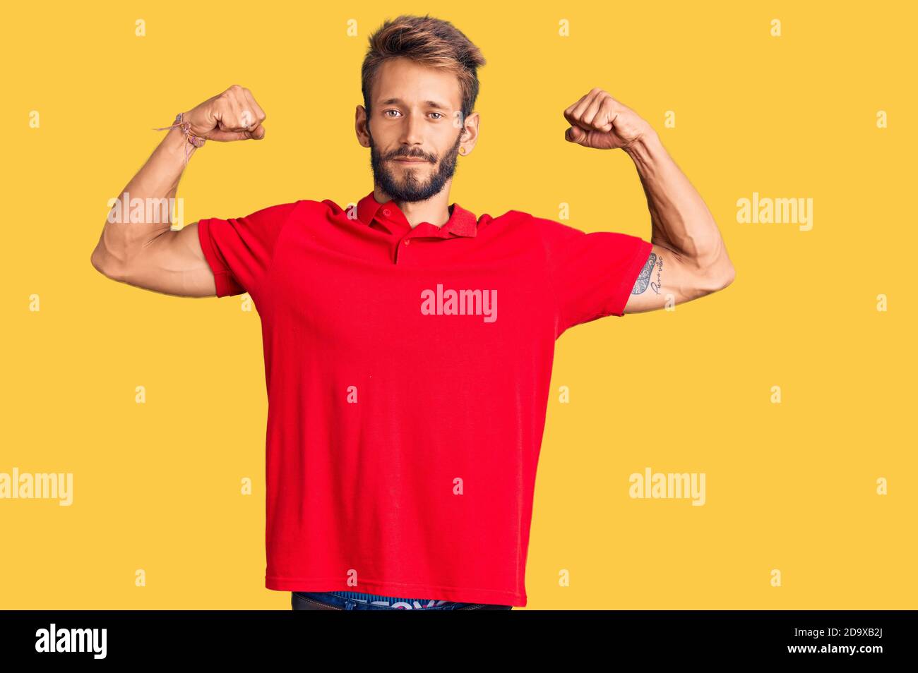 Handsome blond man with beard wearing casual clothes showing arms ...