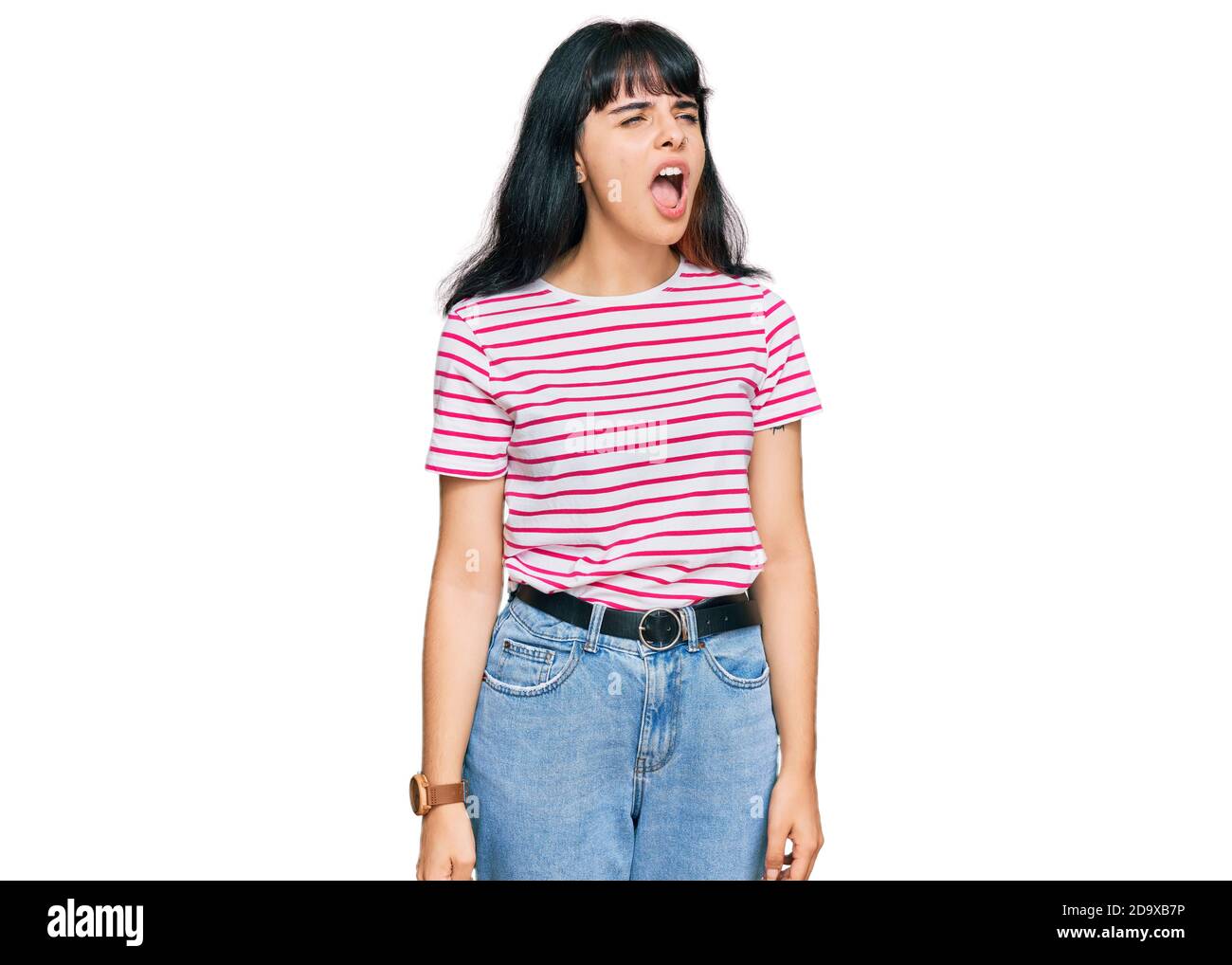 Young hispanic girl wearing casual clothes angry and mad screaming ...