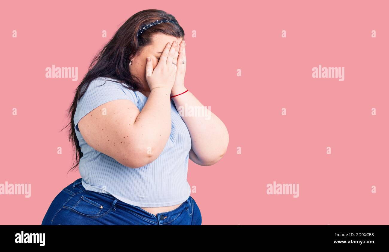 Young plus size woman wearing casual clothes with sad expression ...