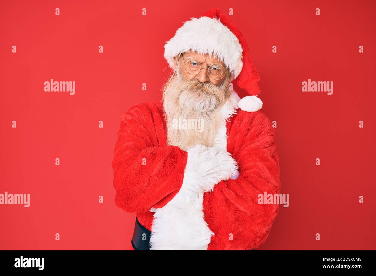 Old senior man with grey hair and long beard wearing traditional santa ...