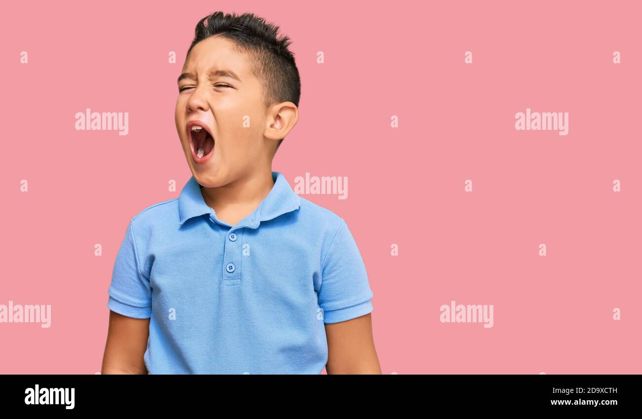 Little boy hispanic kid wearing casual clothes angry and mad screaming ...