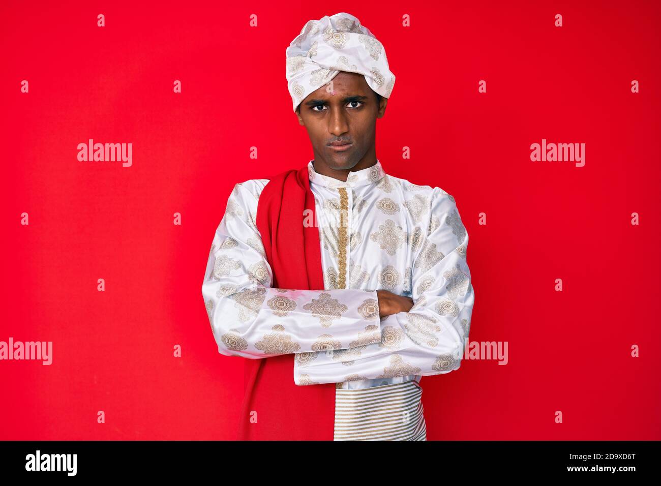 Handsome indian man wearing tradition sherwani saree clothes skeptic ...