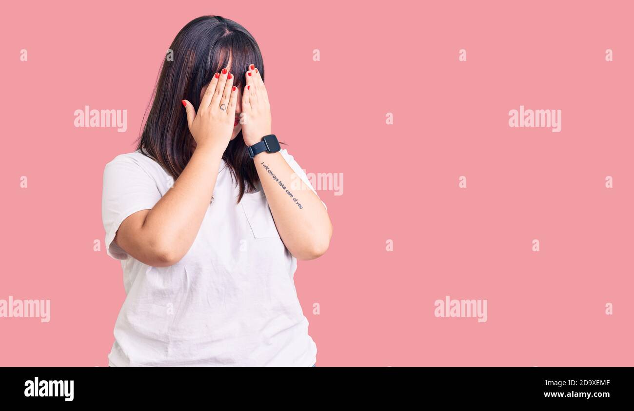 Young plus size woman wearing casual clothes with sad expression ...