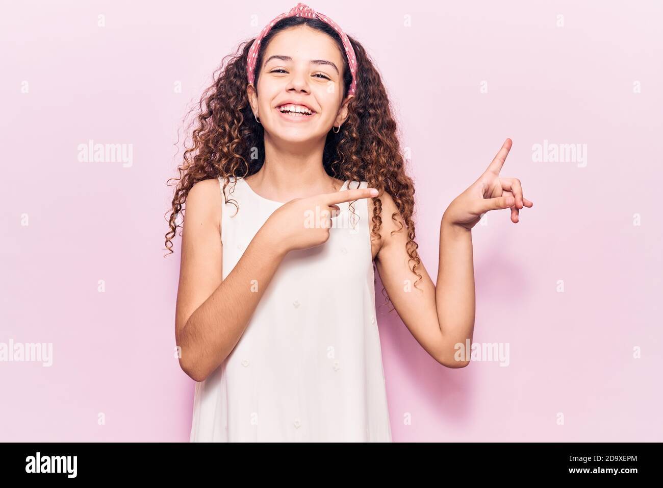 Beautiful kid girl with curly hair wearing casual clothes smiling and ...