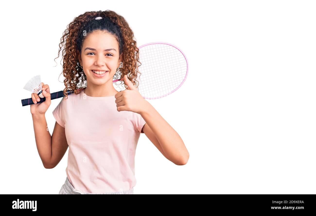 Beautiful kid girl with curly hair holding badminton racket and ...