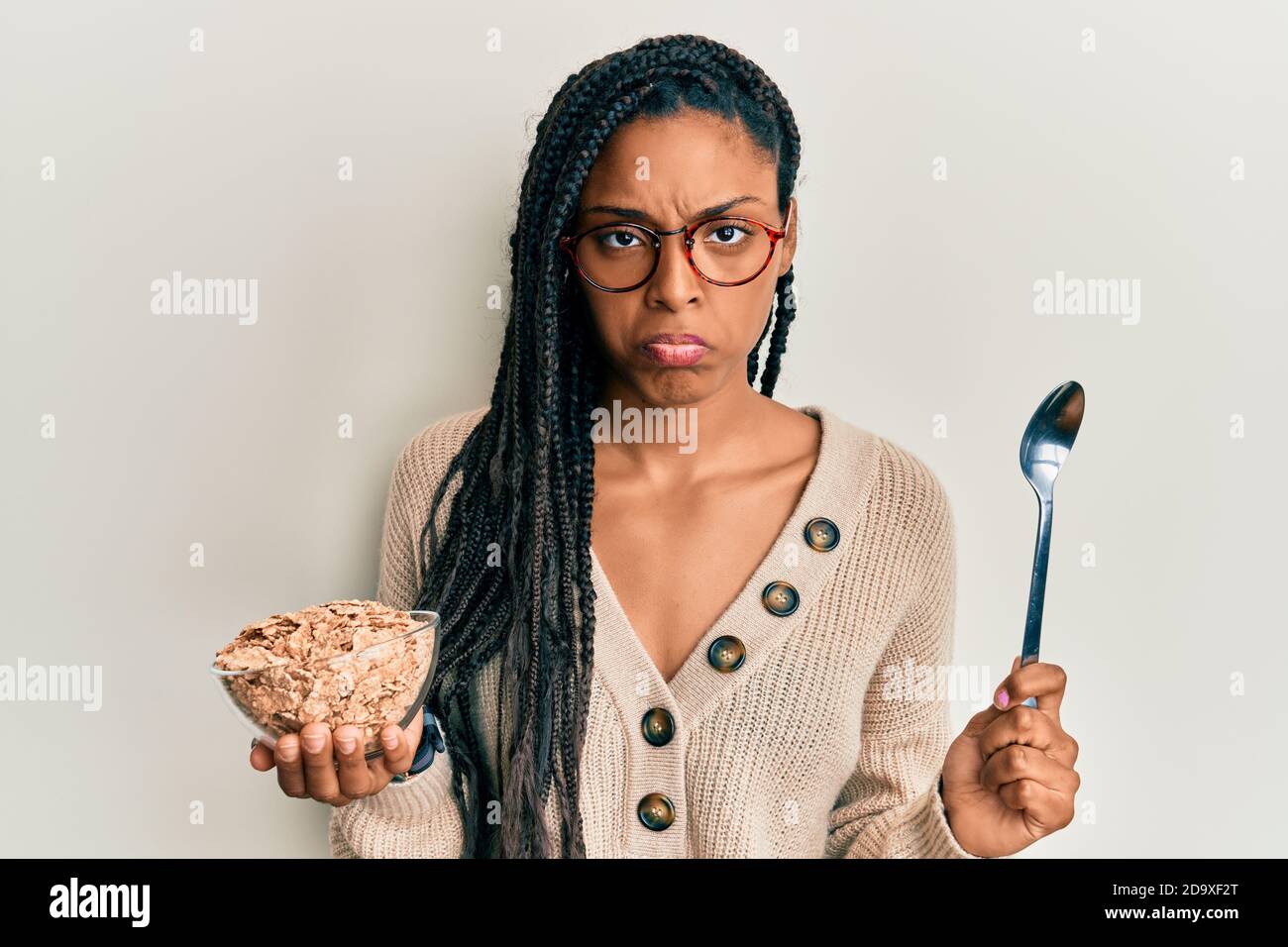 African american woman with braids eating healthy whole grain cereals ...