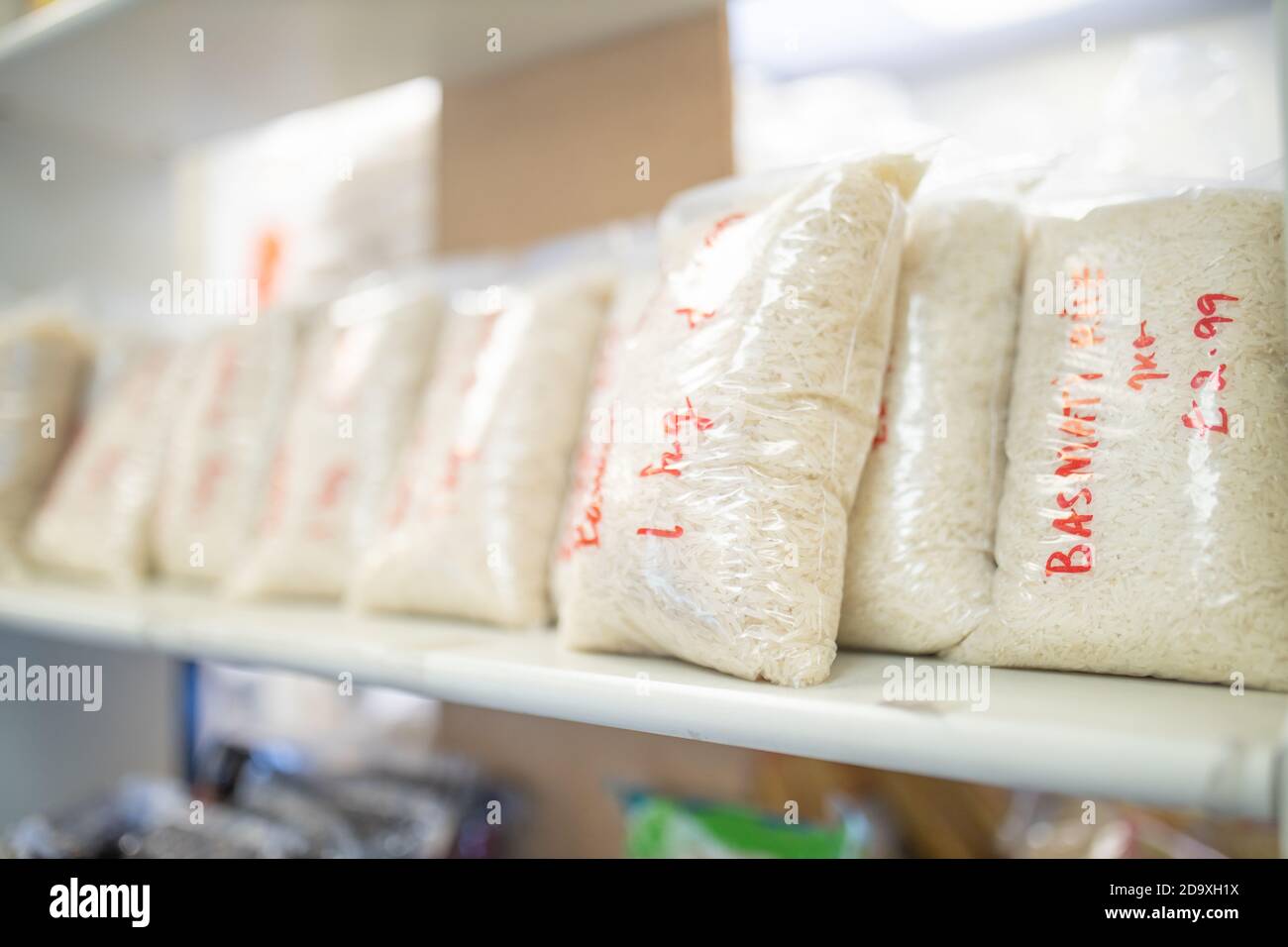 Rice Packed in Plastic Bags and on a Shelf Ready for Sale Stock Photo ...