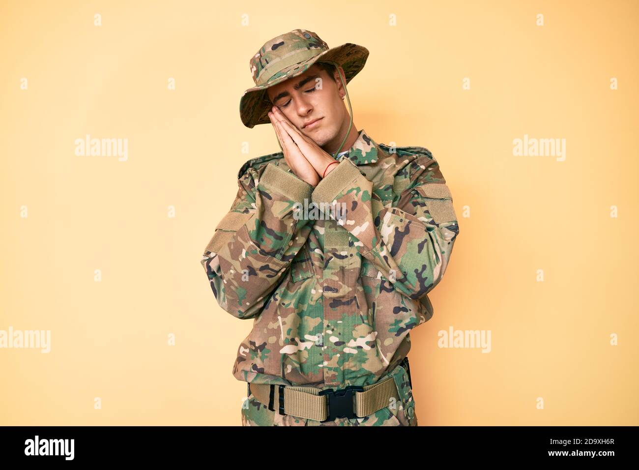 Young handsome man wearing camouflage army uniform sleeping tired ...