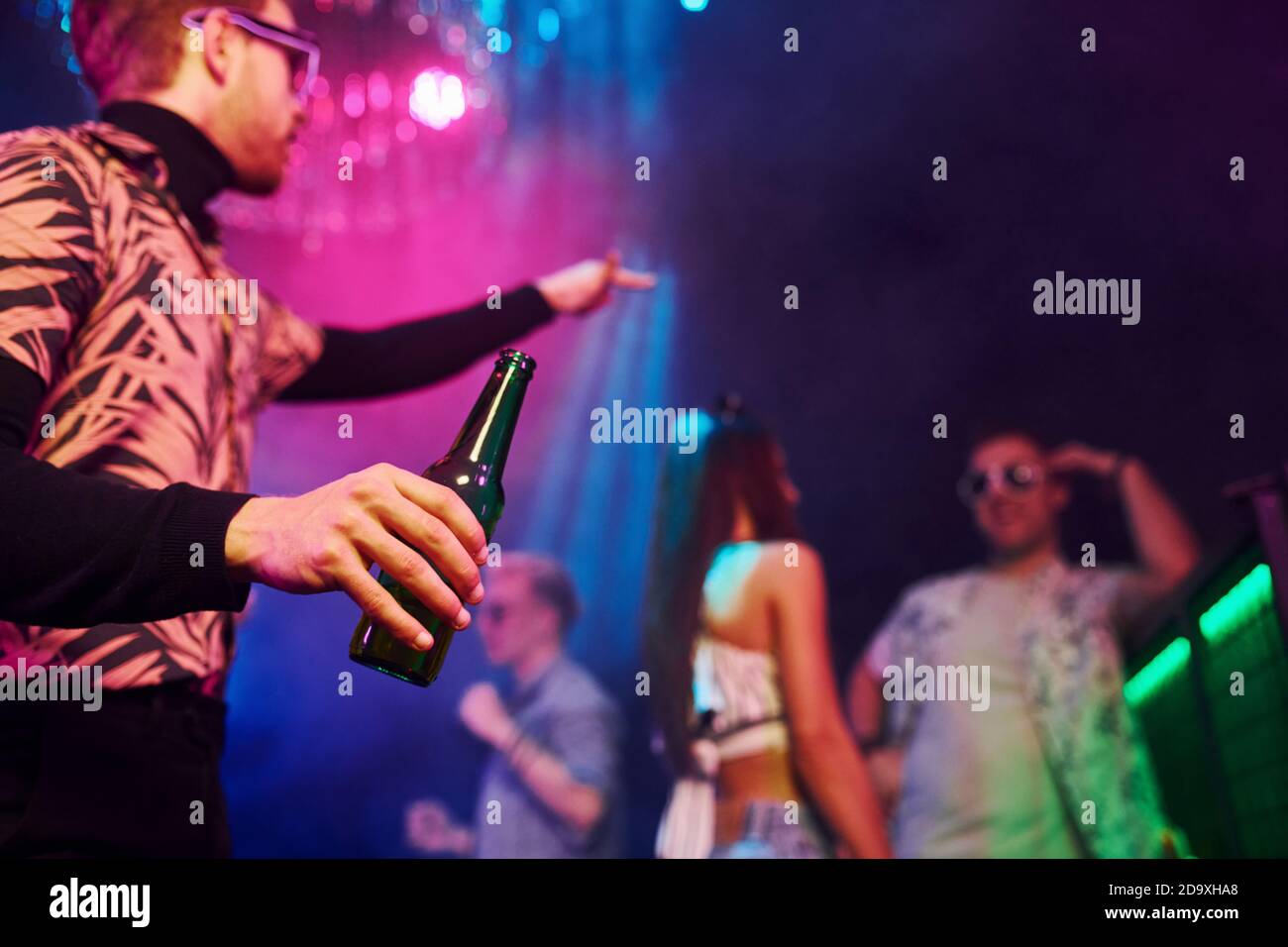 Party with alcohol. Young people is having fun in night club with ...