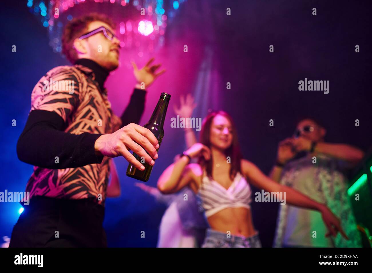 Party with alcohol. Young people is having fun in night club with ...