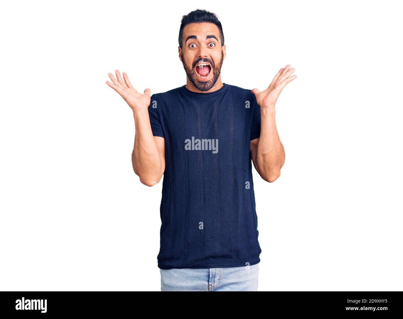 Young hispanic man wearing casual clothes celebrating victory with ...