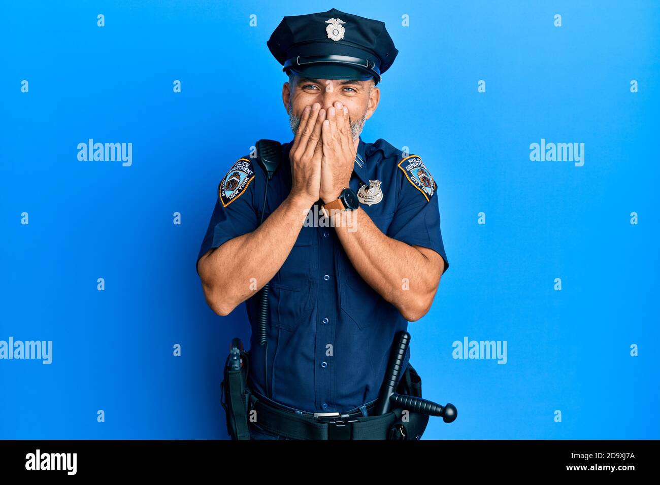 Middle age handsome man wearing police uniform laughing and embarrassed ...