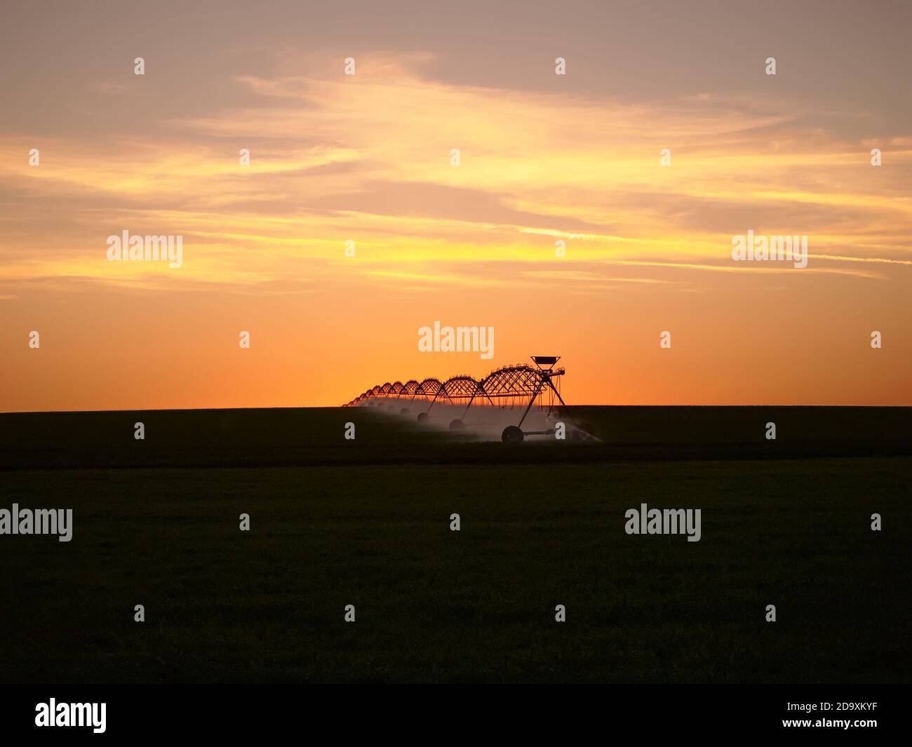 Center pivot irrigation system in the farm field at sunset Stock Photo ...