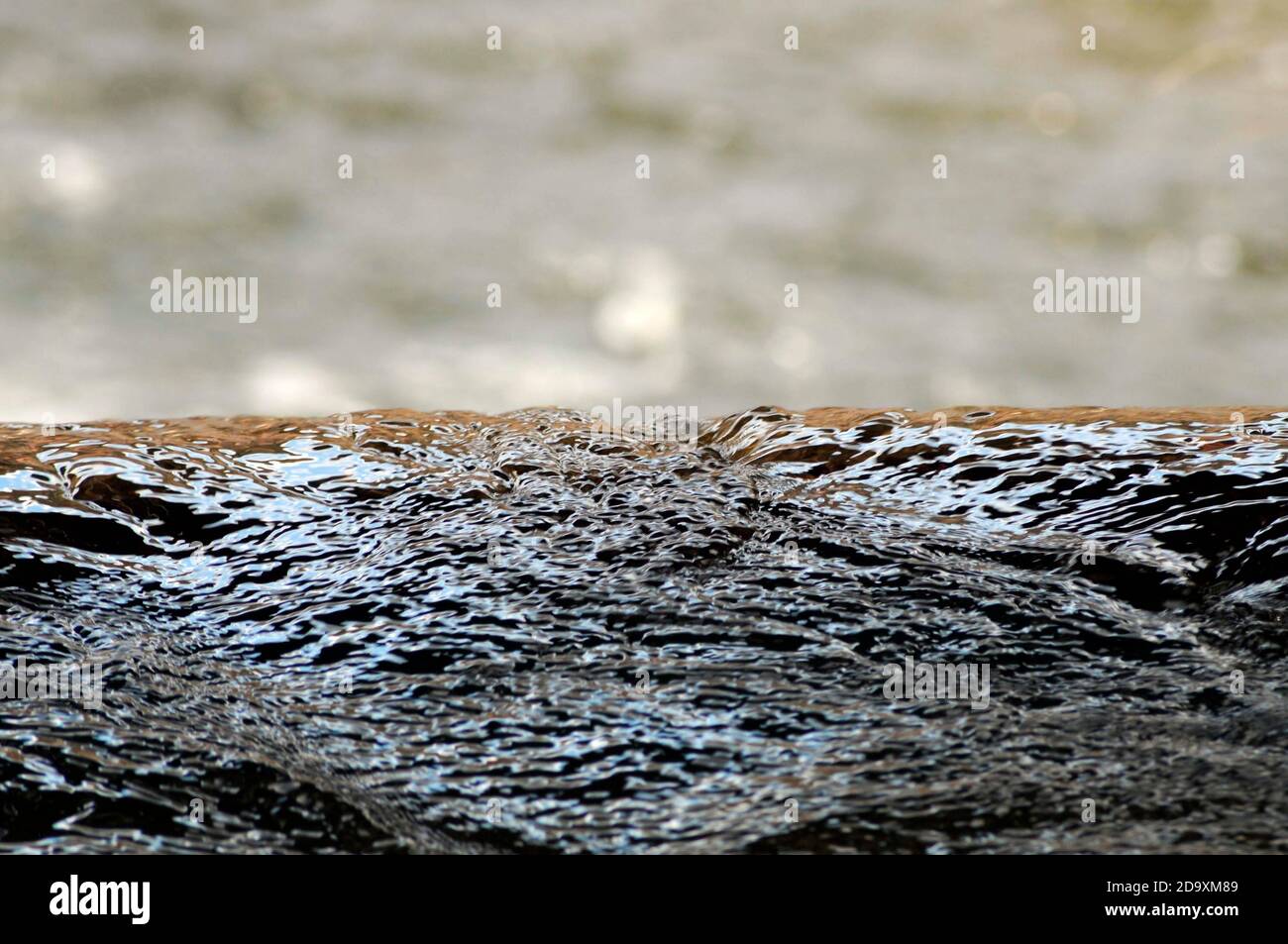 regulated water stream for flood control at a lake in the mountains ...